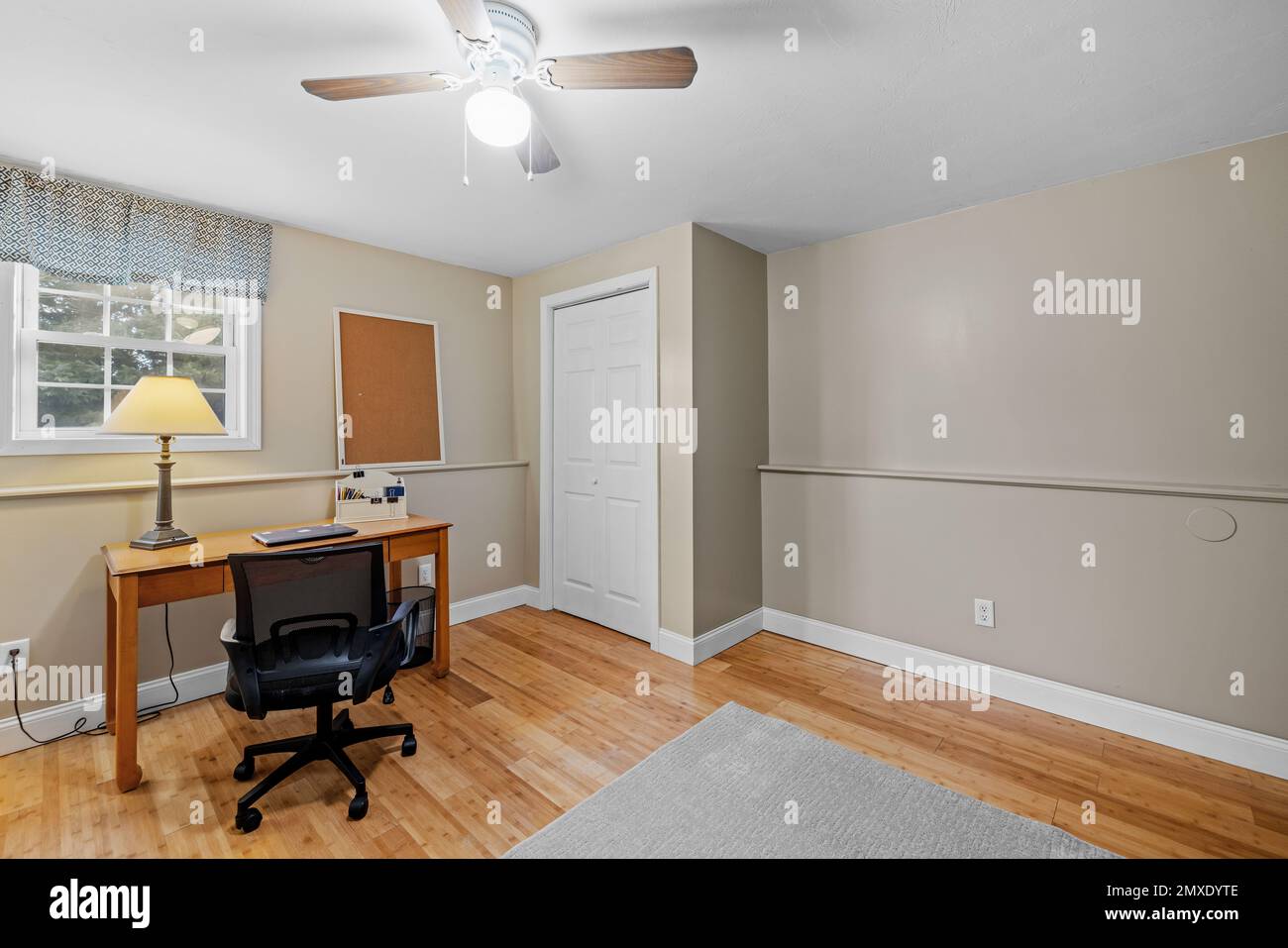 The interior of a modern suburban home office with a table and a ...