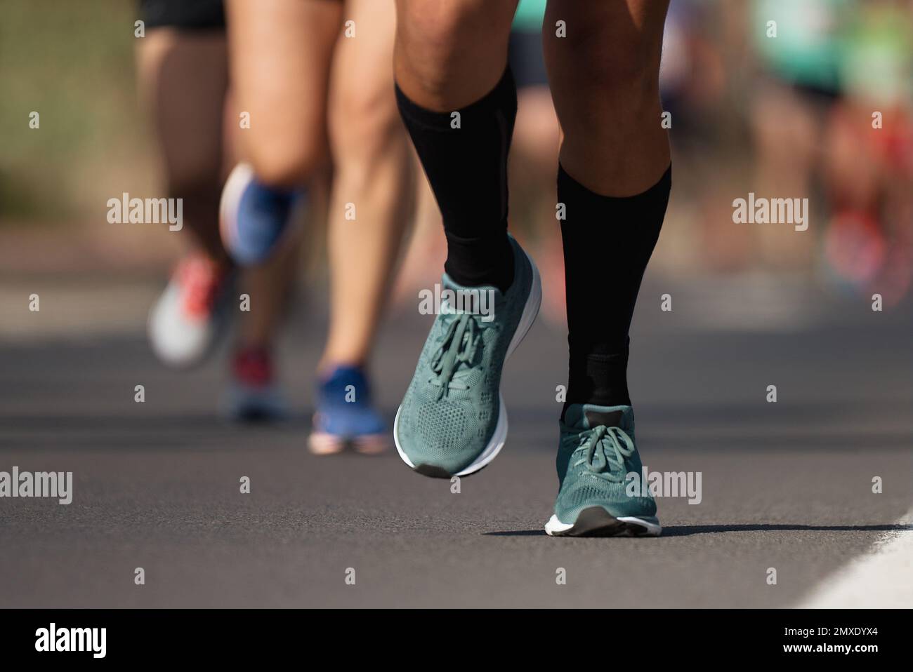 Marathon running race, people feet on city road Stock Photo - Alamy