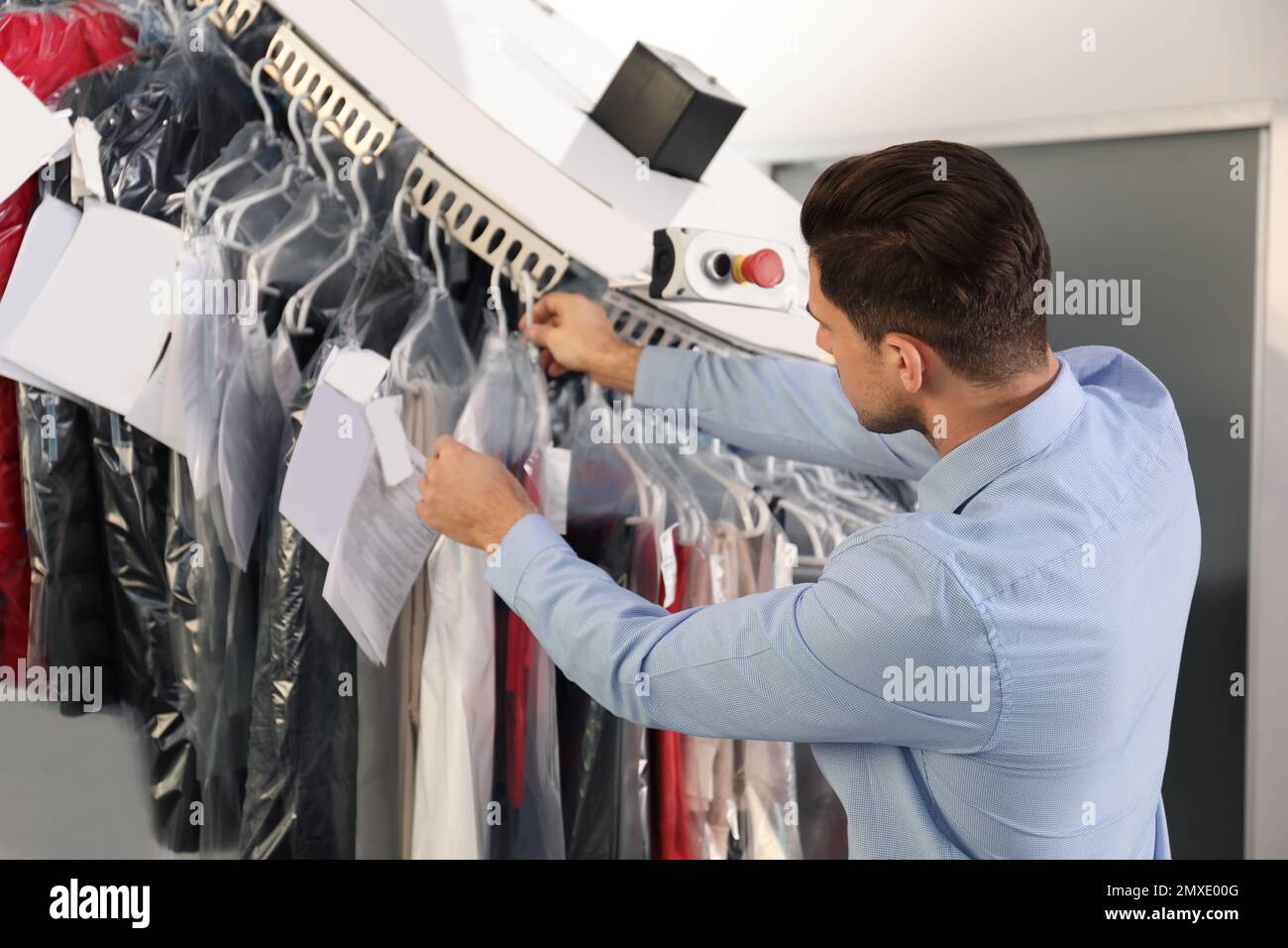 Man taking shirt from hanger hi-res stock photography and images - Alamy