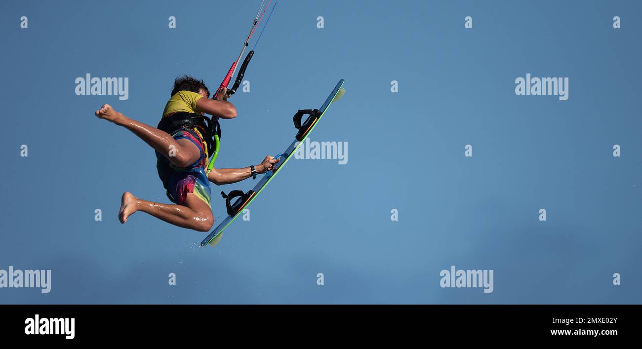 Athletic man jump on kite surf board on a sea waves, kiteboarding ...