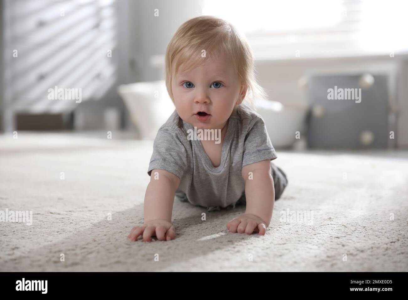Adorable little baby on floor at home Stock Photo - Alamy