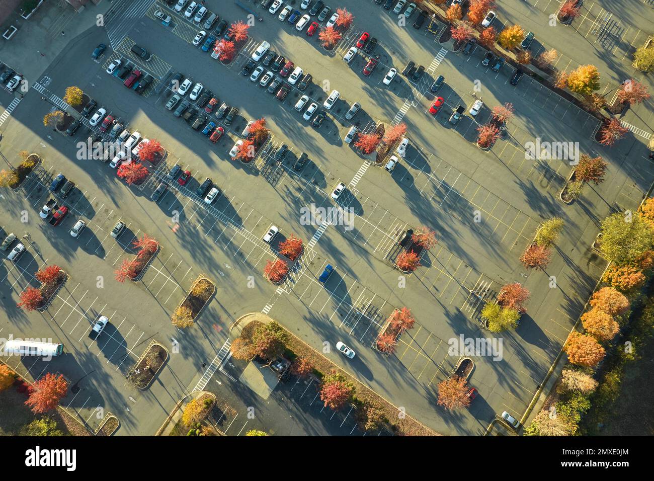 Aerial view of many colorful cars parked on parking lot with lines and ...