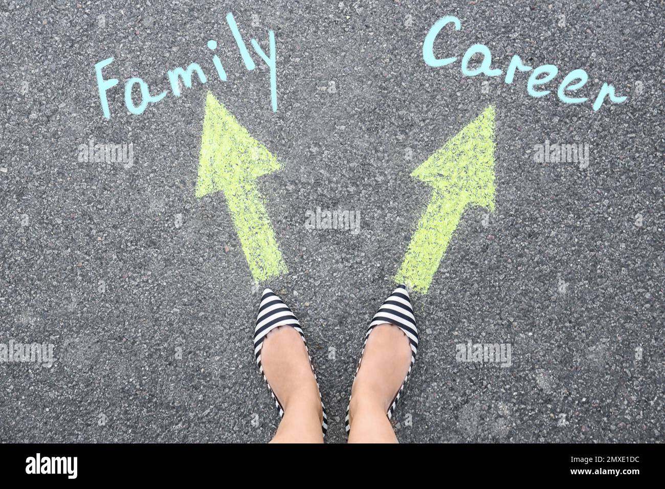 Life choice. Woman on road near arrows with directions to family and ...