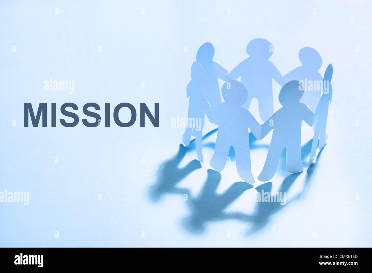 Paper human figures and text MISSION on light blue background Stock ...
