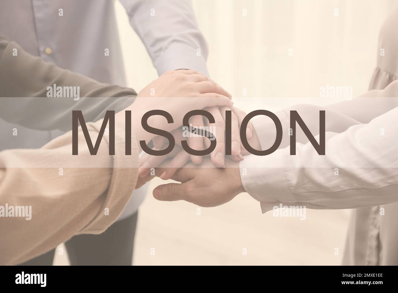 People holding hands together on light background, closeup. Mission ...