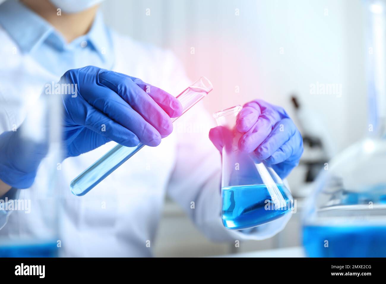 Scientist pouring liquid into flask, closeup. Laboratory analysis Stock ...