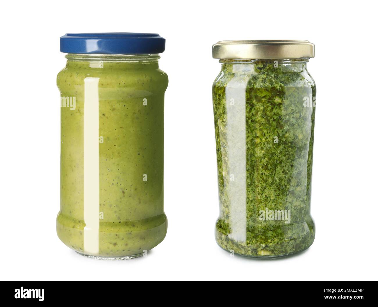 Delicious pesto sauce in glass jars on white background Stock Photo - Alamy