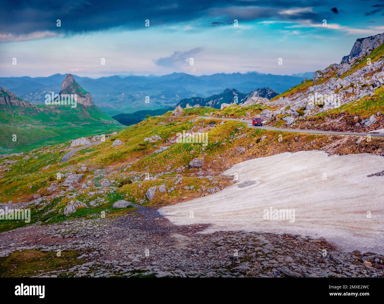 Red car driving to the top of Sedlo pass. Wonderful spring scene of ...