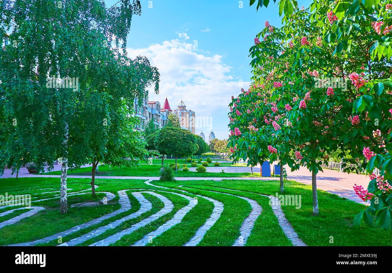 The small labyrinth on the lawn in a beautiful spring park, located on ...