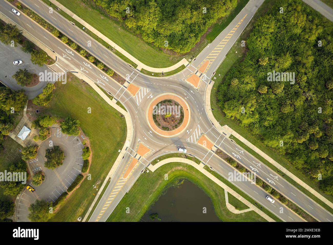 Aerial view of road roundabout intersection with moving cars traffic. Rural circular ...