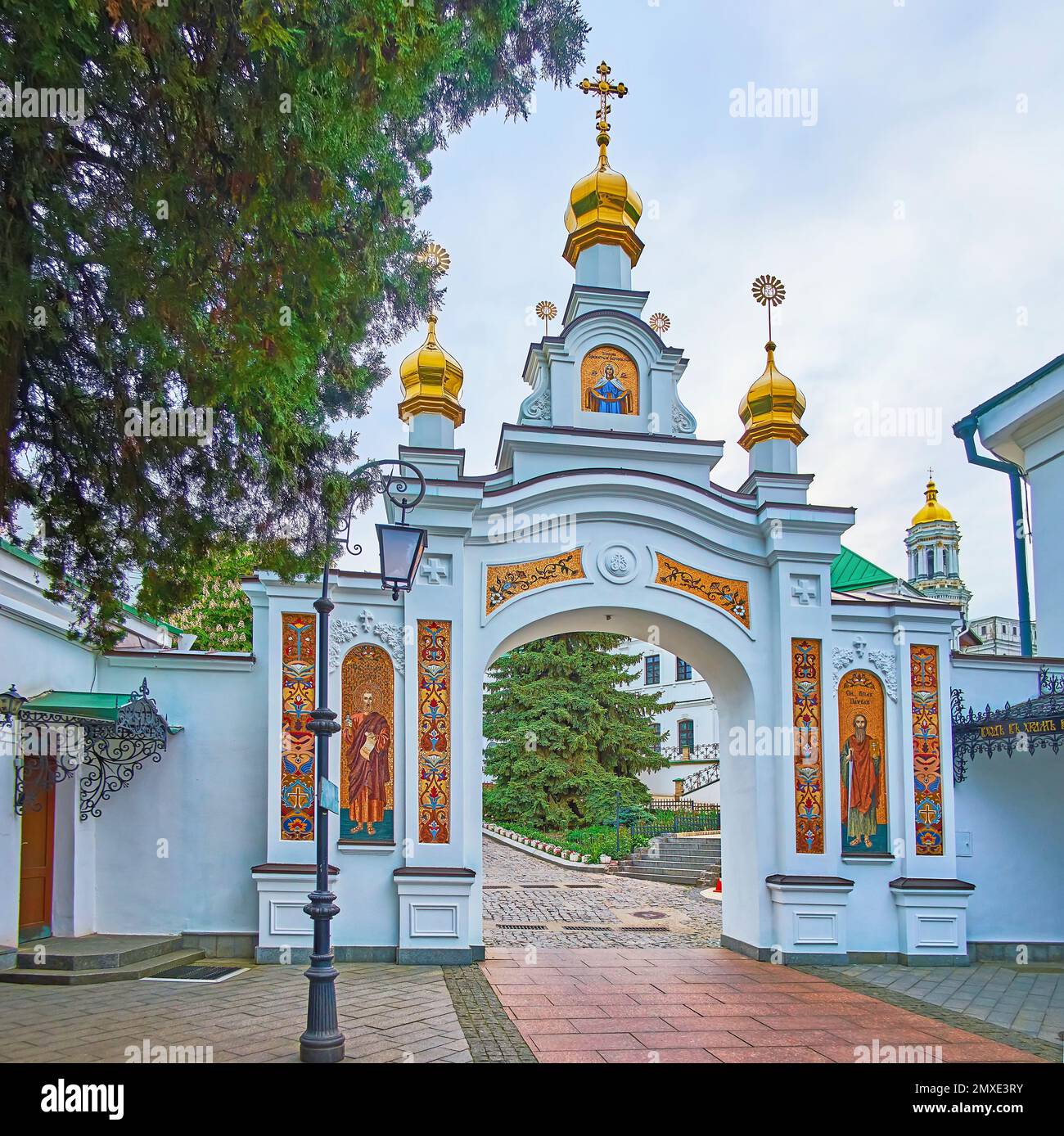 The richly decorated frescoed gate, topped with gilt onion domes, the ...
