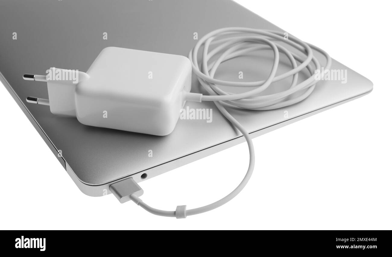 Laptop and charger on white background, closeup. Modern technology ...