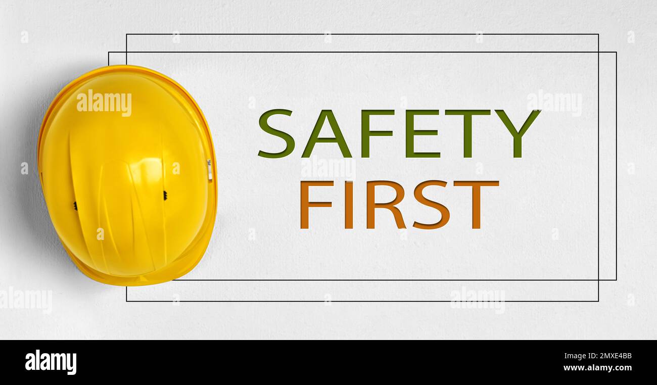 Safety first. Hard hat on light background Stock Photo - Alamy