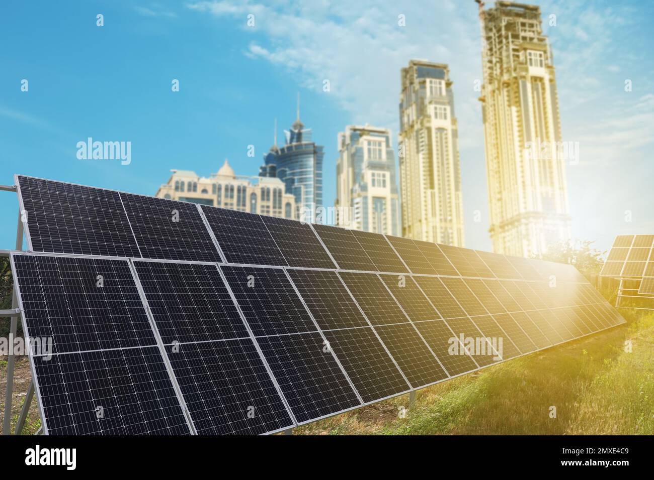 Cityscape and solar panels installed outdoors. Alternative energy ...