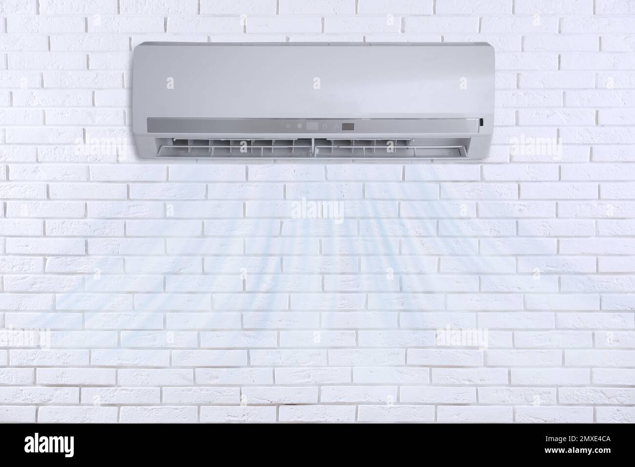 Modern air conditioner on white brick wall indoors Stock Photo - Alamy