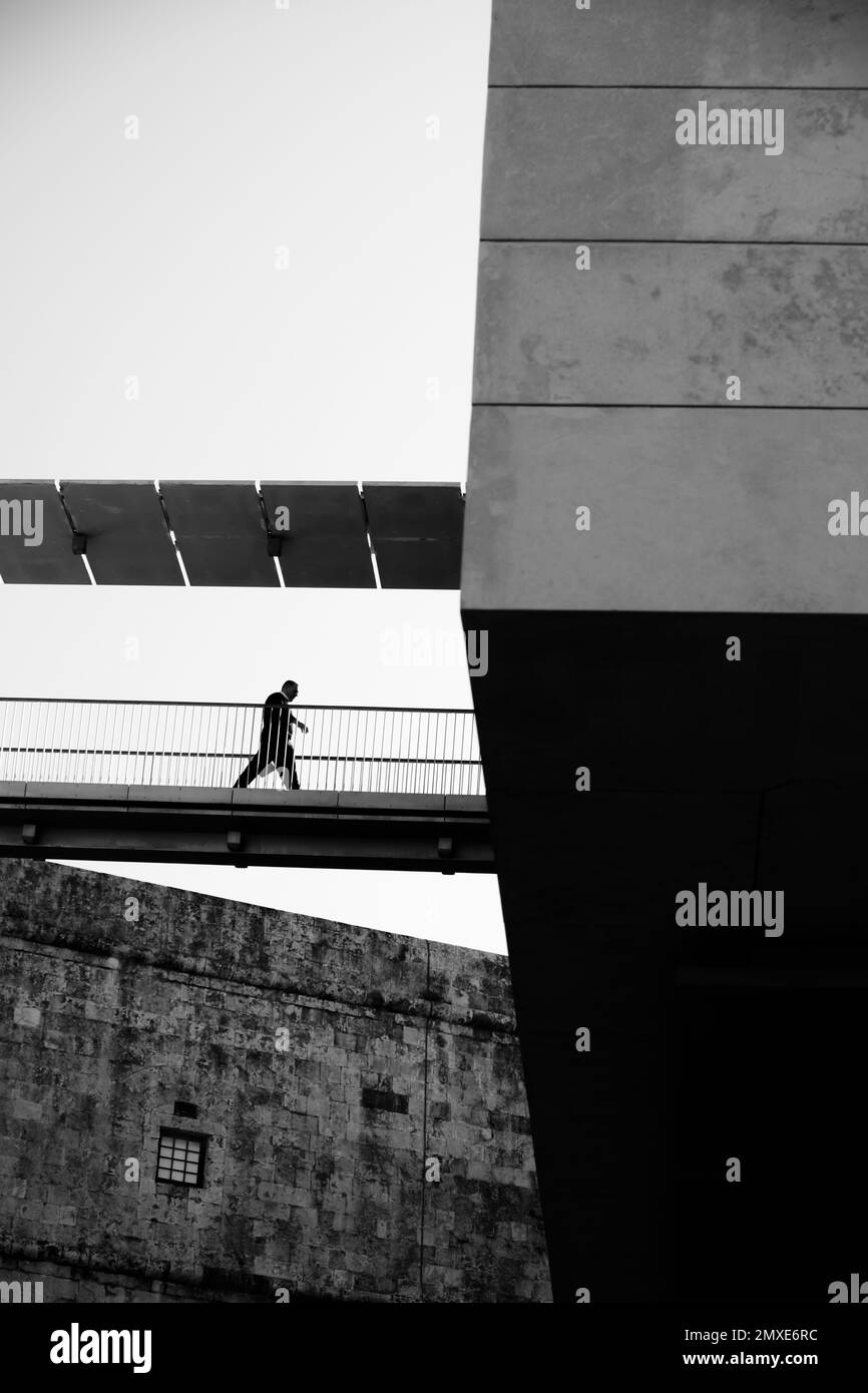 businessman walking in a stairway suspended between two buildings Stock ...