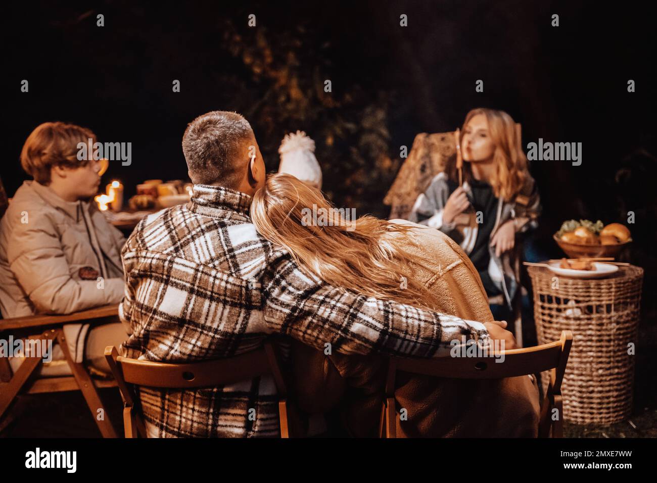 Family trailer travel. Children,brother sister,mom dad fry sausages on ...