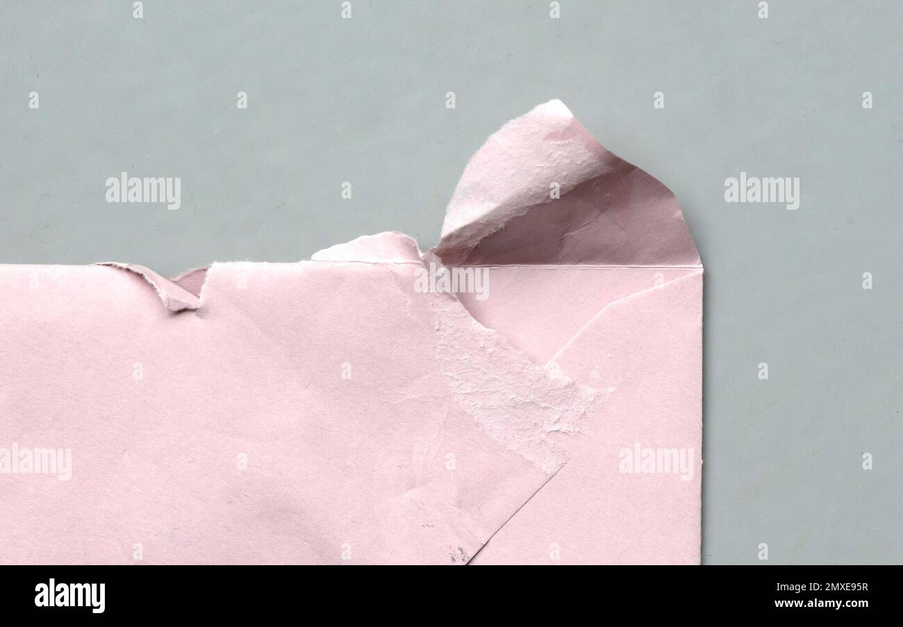 Torn (opened) envelope on a grey background Stock Photo - Alamy