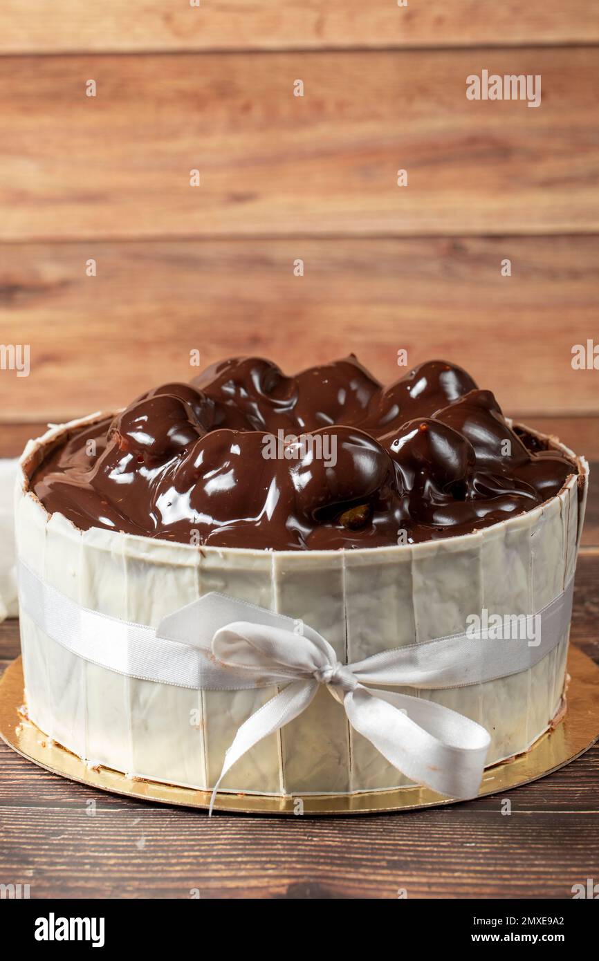 Profiterole cake. Cake with profiteroles surrounded by white chocolate ...