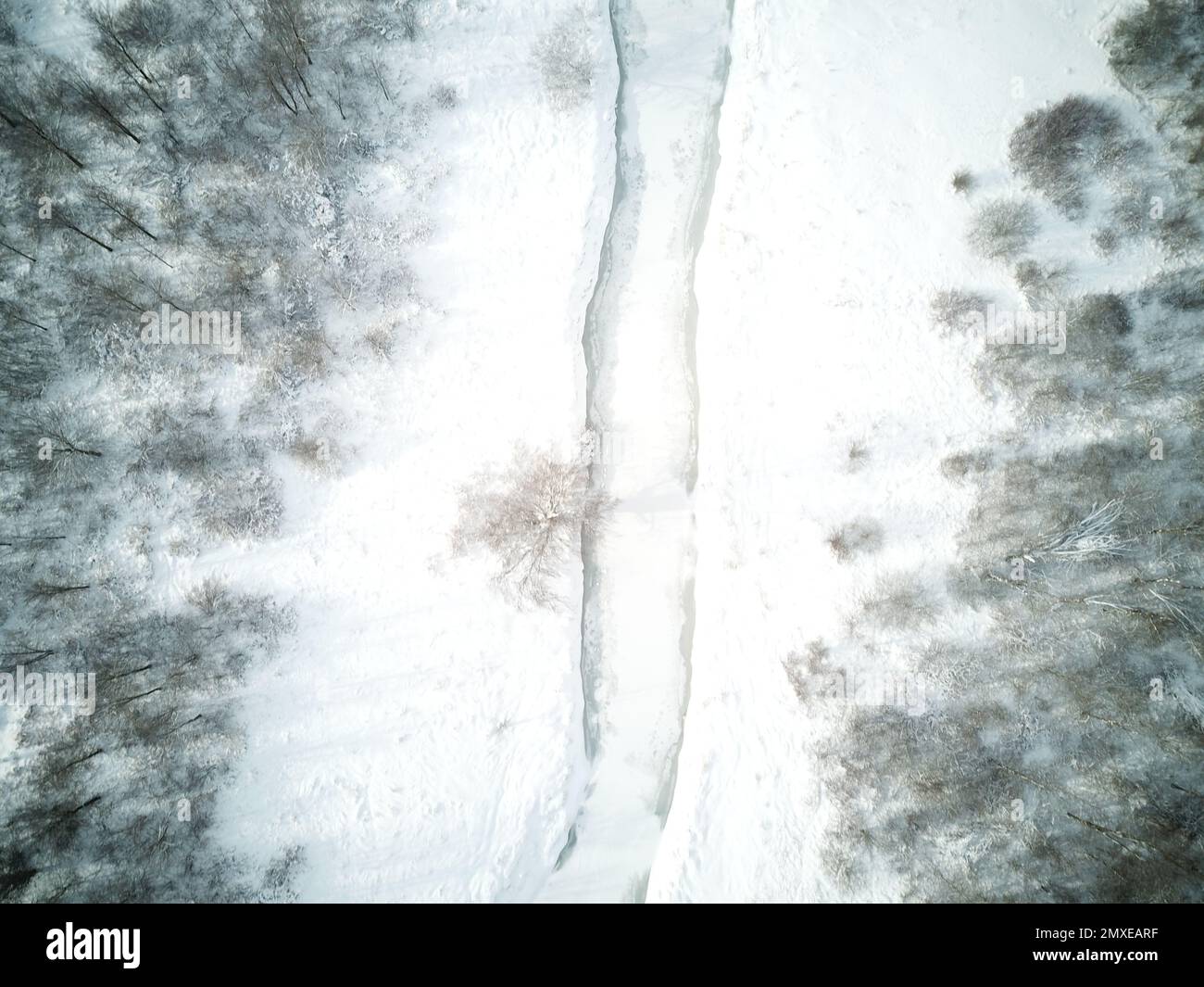 A top view of a frozen river in a snowy forest Stock Photo - Alamy
