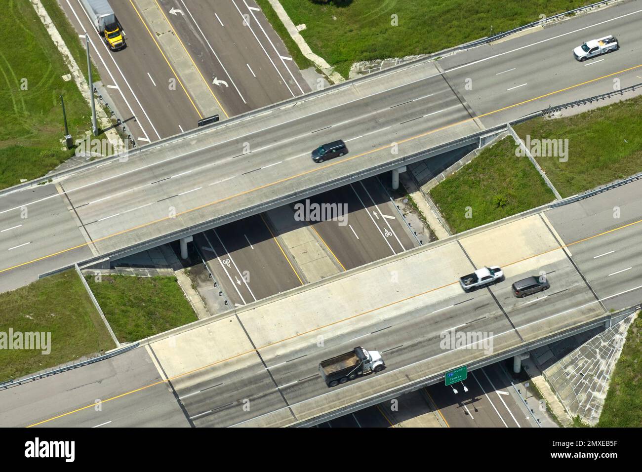 Aerial view of freeway overpass junction with fast moving traffic cars ...
