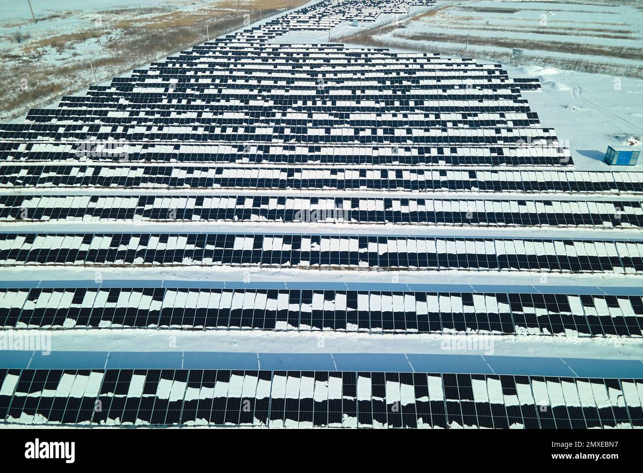 Aerial view of snow melting from covered solar photovoltaic panels at ...