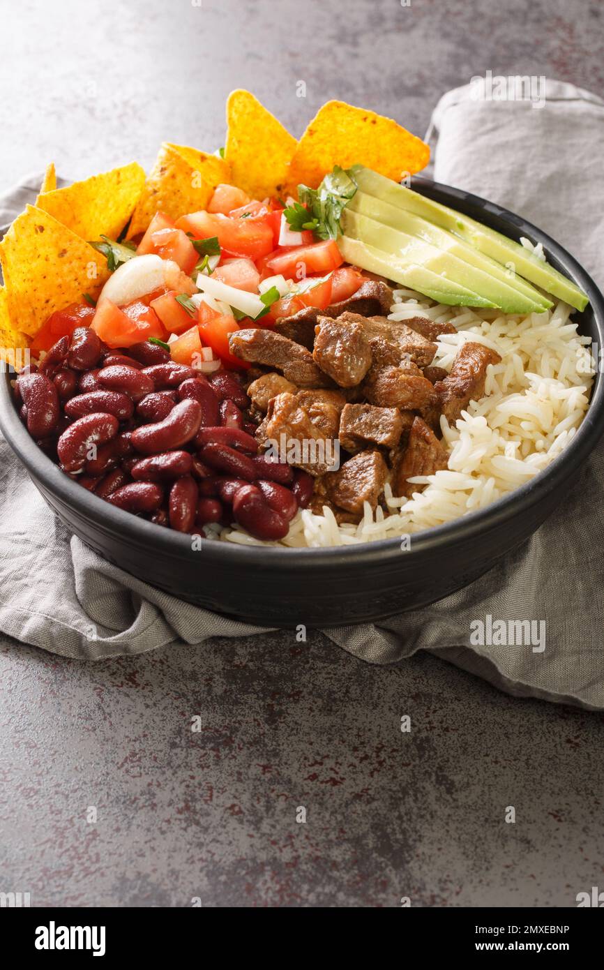 Chifrijo Costa Rican Crispy Pork, Rice and Beans closeup on the plate ...