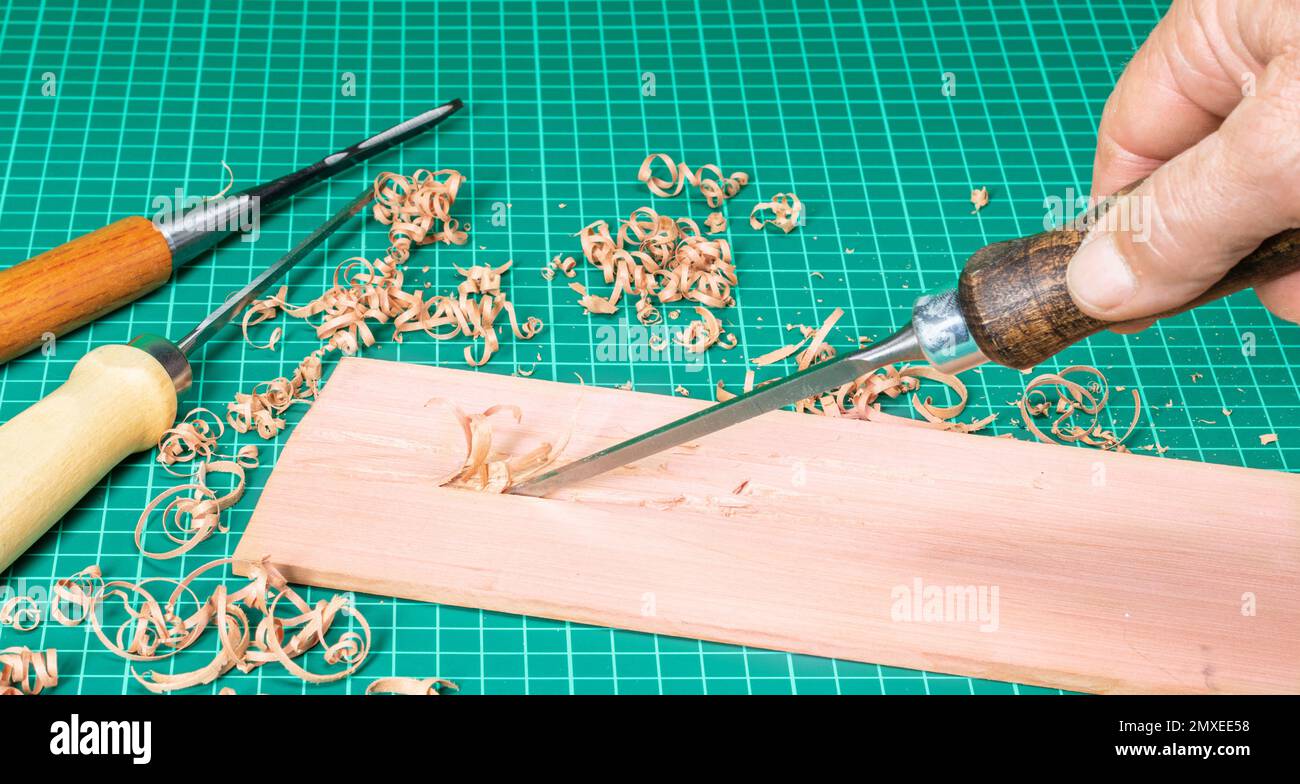 planing a narrow chisel plank of pink pear Stock Photo - Alamy