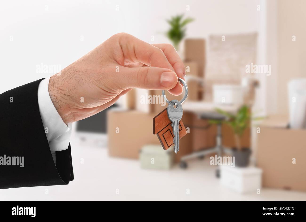 Man with key in new modern apartment, closeup Stock Photo - Alamy
