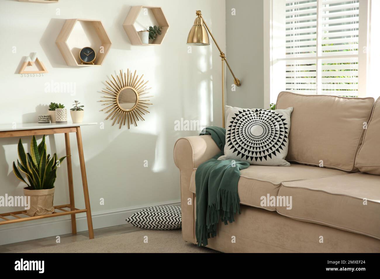 Stylish beige sofa in modern living room interior Stock Photo - Alamy