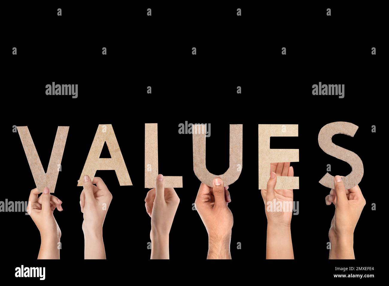 People making word VALUES of letters on black background Stock Photo ...