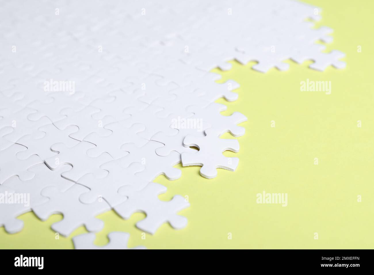 Blank white puzzle pieces on yellow background Stock Photo - Alamy