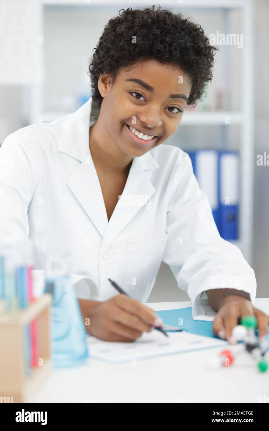 happy medical student taking notes for research Stock Photo - Alamy