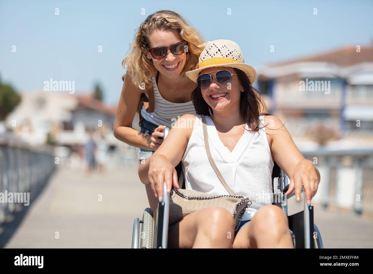 beautiful women friends one disabled wandering on sea side Stock Photo ...