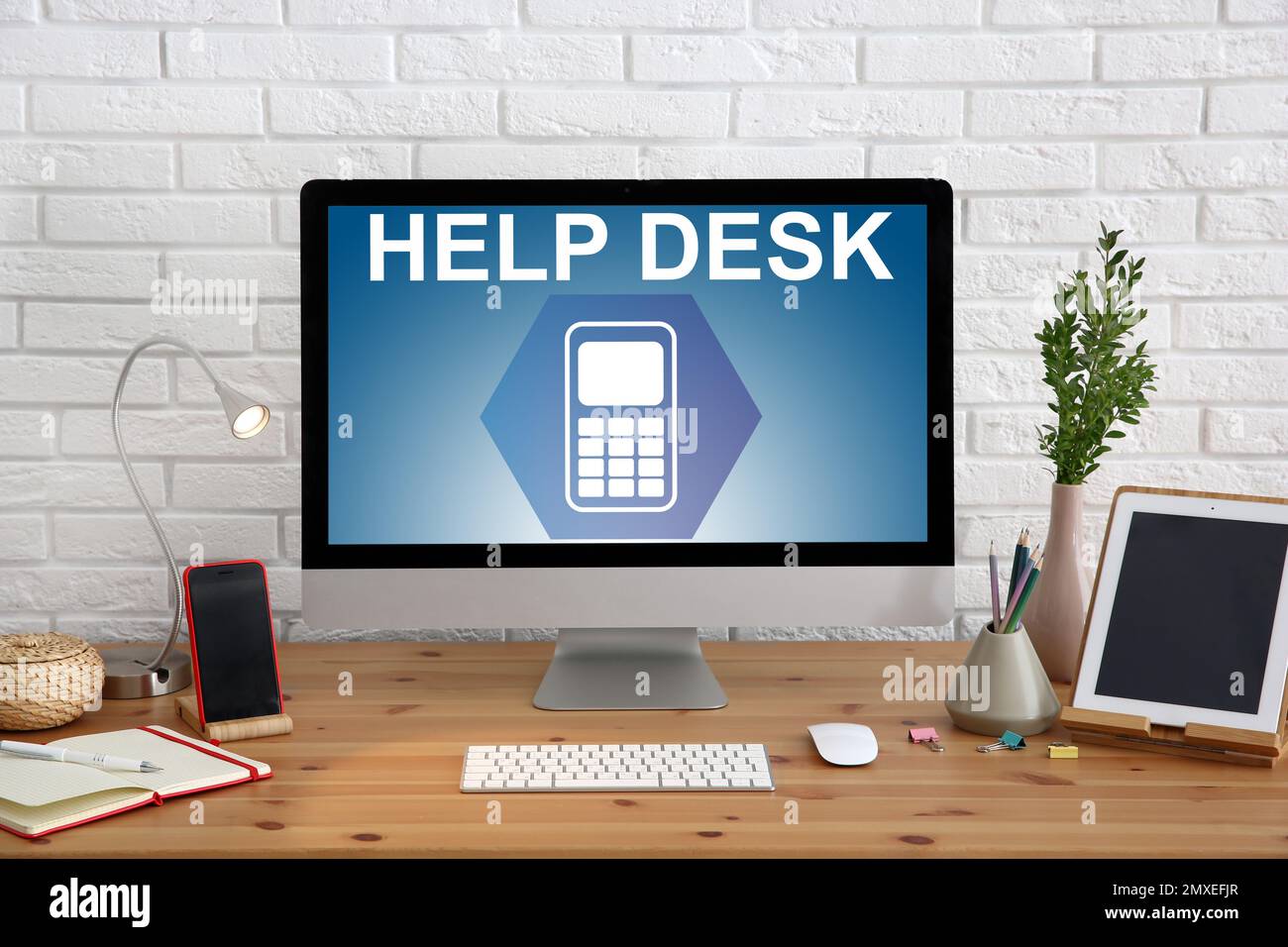 Modern computer and stationery on wooden table. Help desk service Stock Photo - Alamy