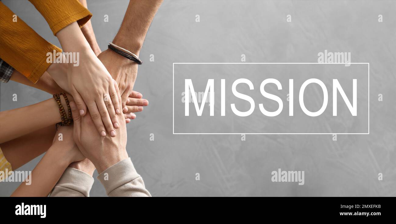 People holding hands together over grey background and text MISSION ...