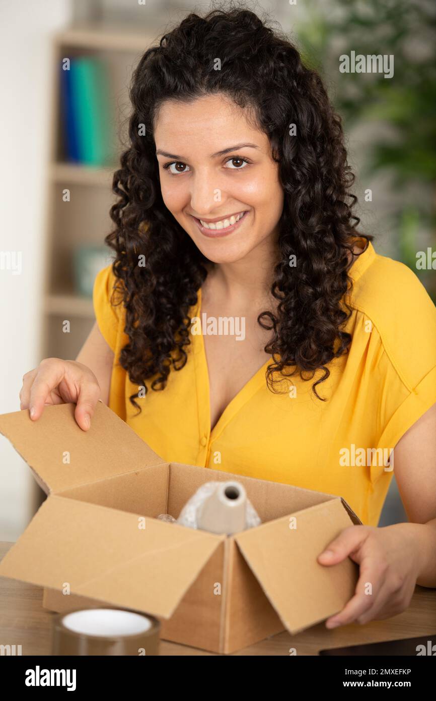beautiful woman unpacking a carton box Stock Photo - Alamy
