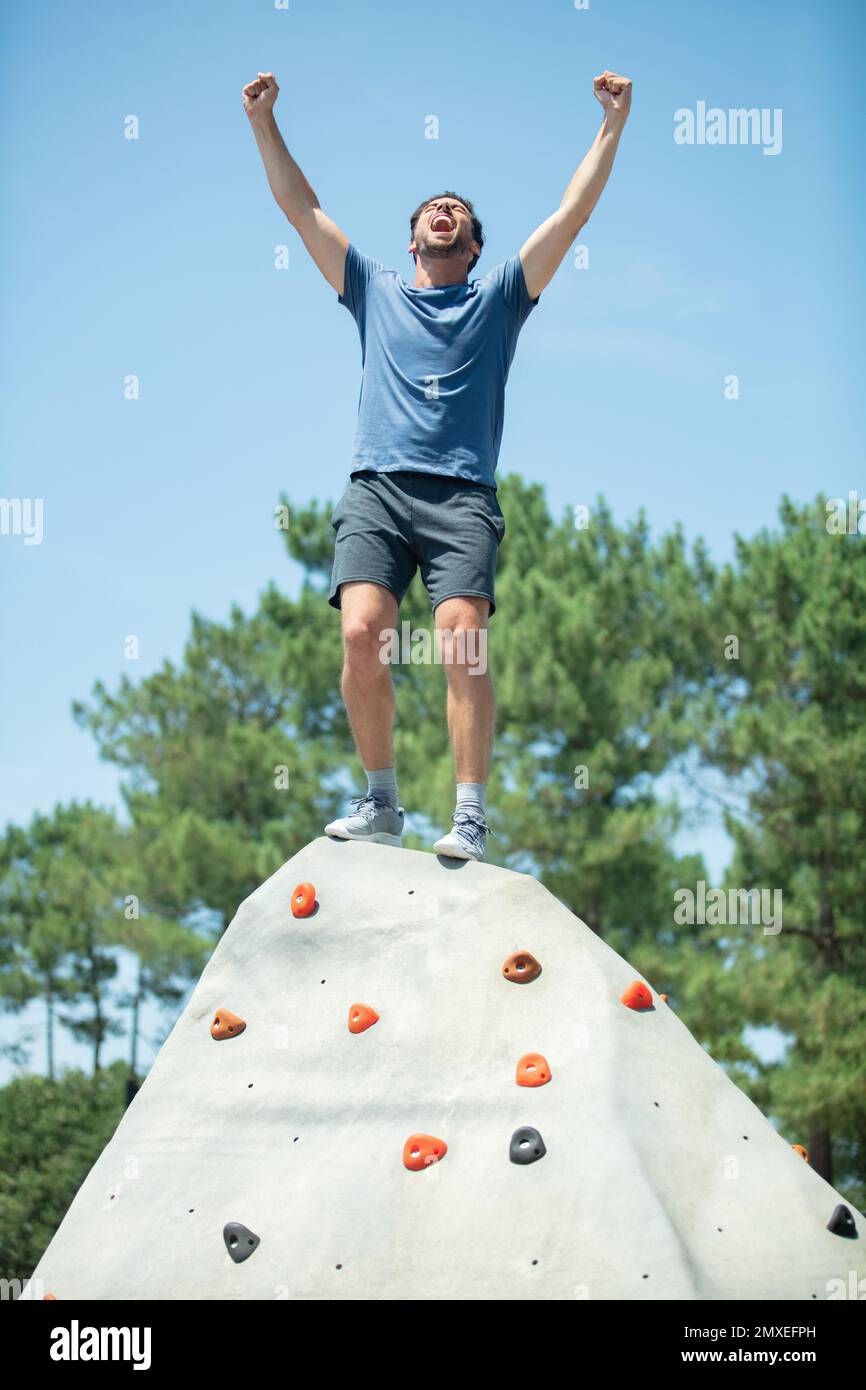 Happy climber top of wall hi-res stock photography and images - Alamy