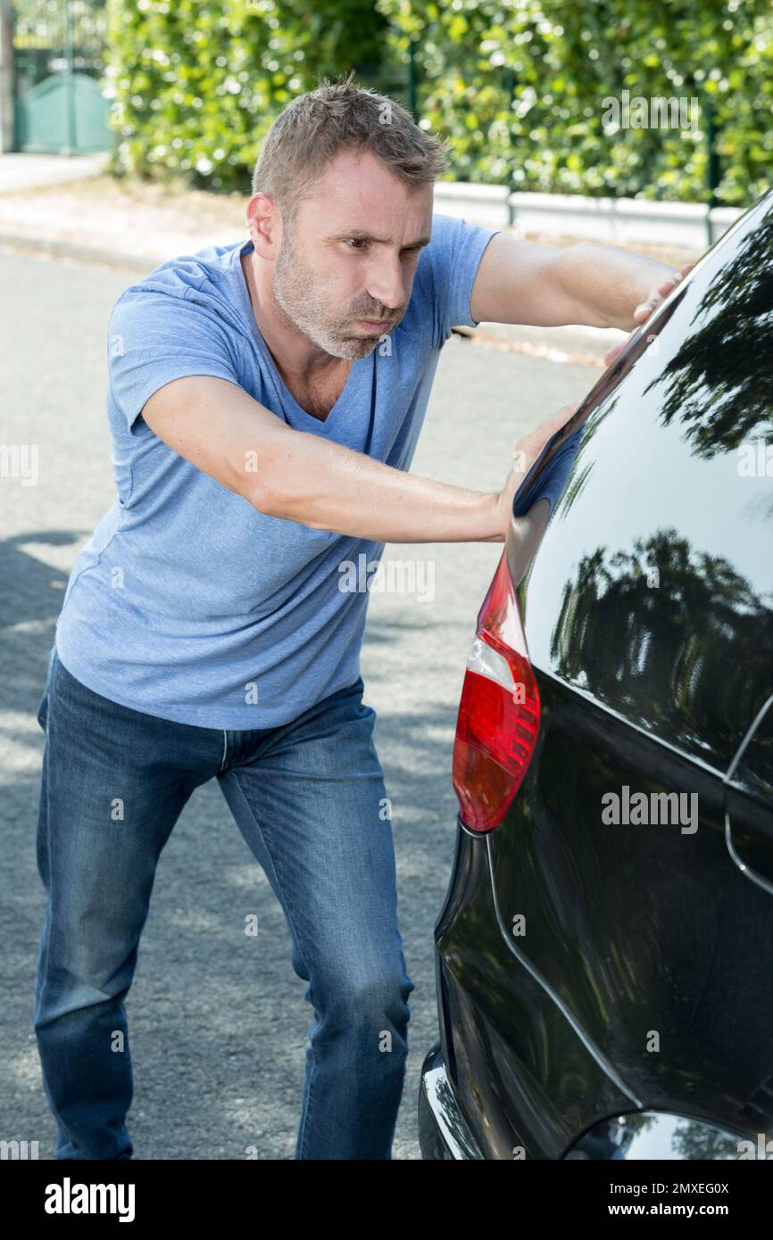 man pushing a car with mechanic problems Stock Photo - Alamy