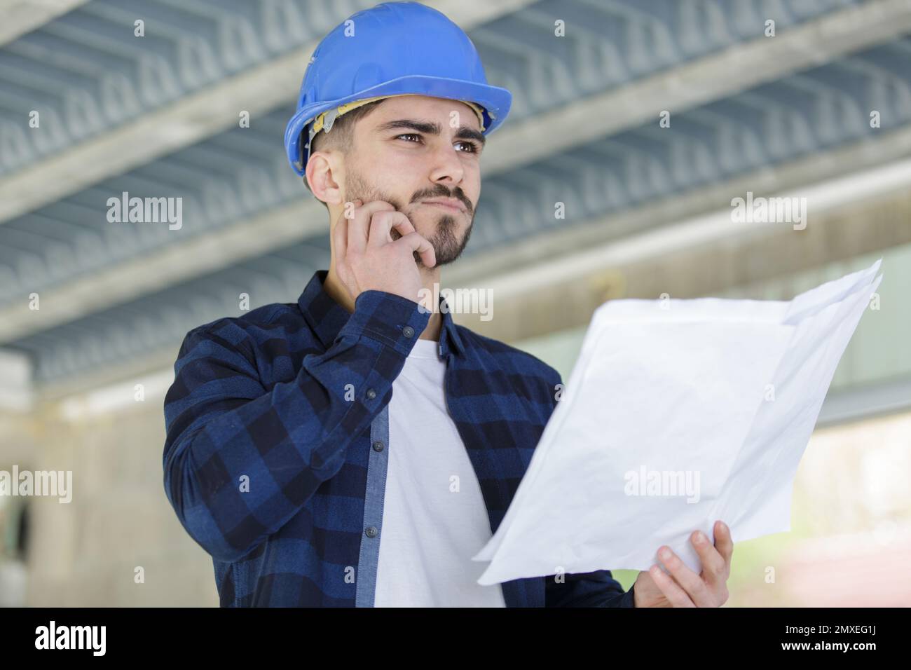 serious builder studying layout plan Stock Photo - Alamy