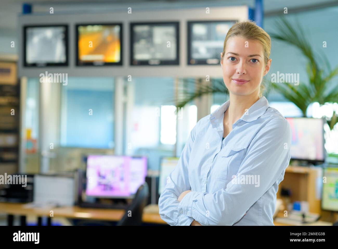 attractive blonde tv presenter looking at the camera Stock Photo - Alamy