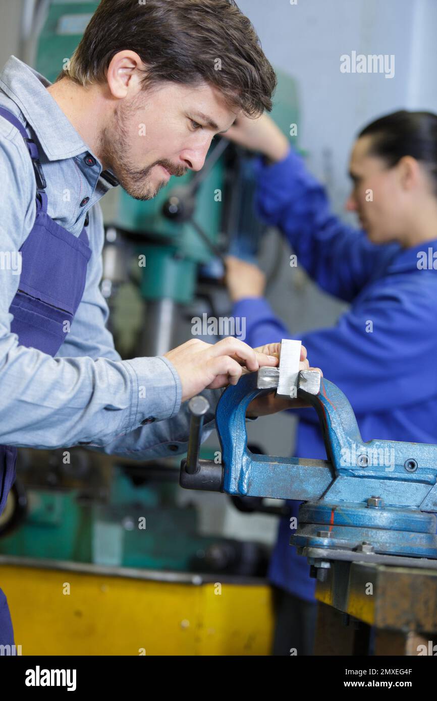 workman securing wood in a vice Stock Photo - Alamy