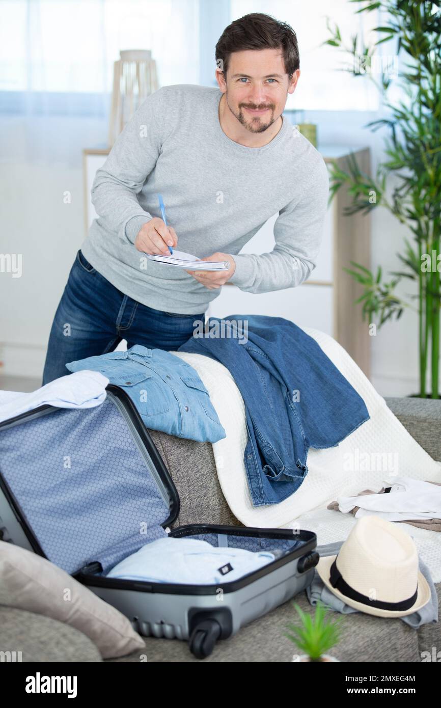 happy man packing the luggage Stock Photo - Alamy