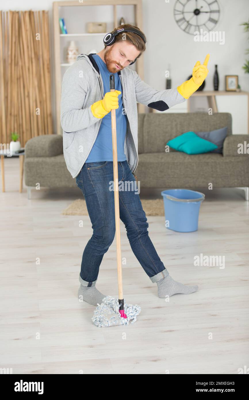 man mopping the floor wearing headphones and dancing Stock Photo - Alamy