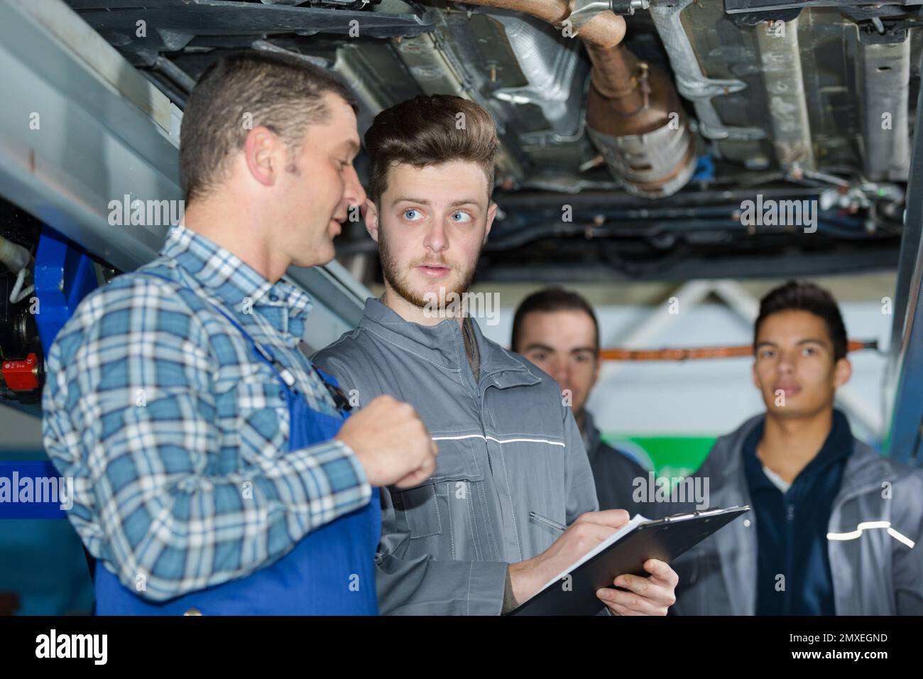 teacher with student in mechanics class Stock Photo - Alamy