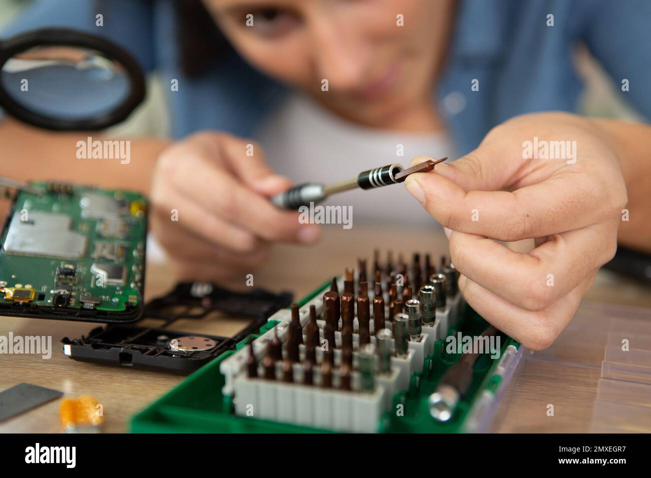 female computer engineer repairing motherboard Stock Photo - Alamy