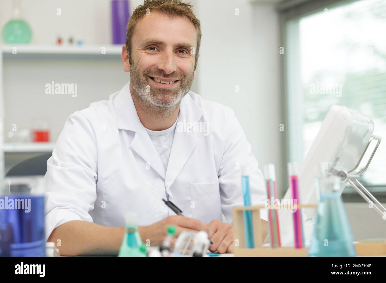 happy male worker with liquids in lab Stock Photo - Alamy