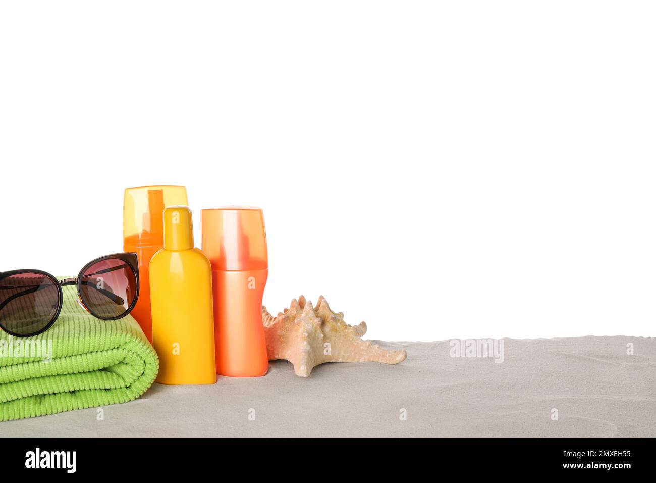 Composition with sun protection products on sand against white ...