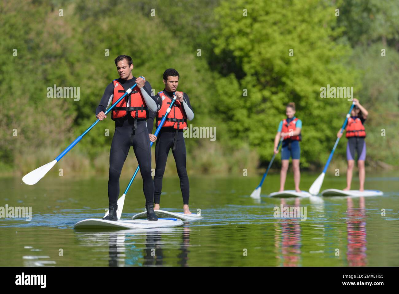 Aerial young people sup boarding hi-res stock photography and images ...