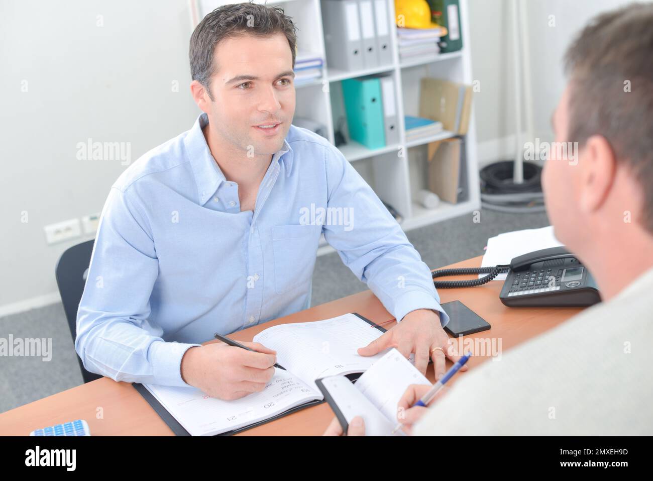 Taking notes during a meeting Stock Photo - Alamy